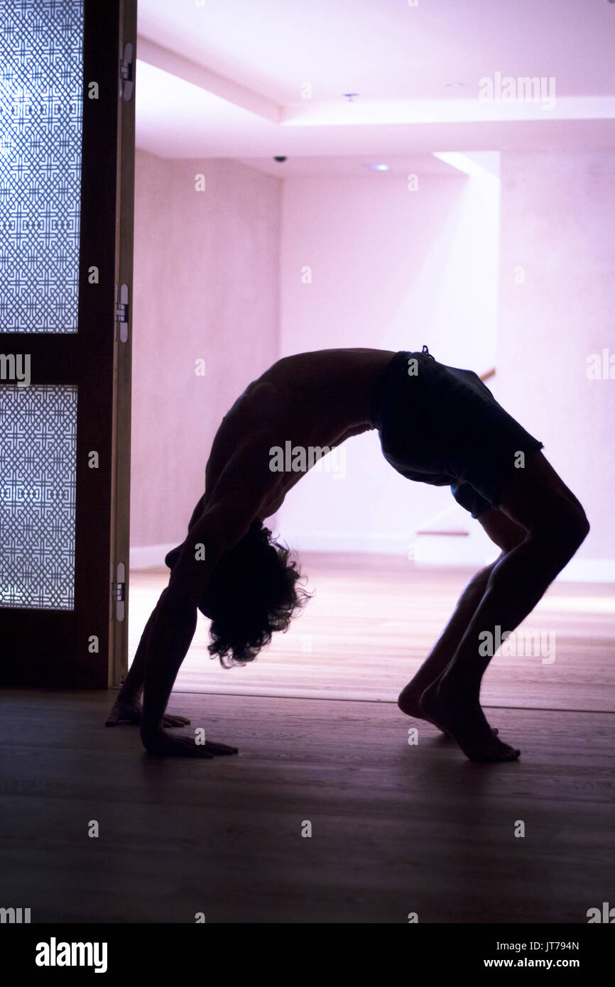 Yoga teacher doing backbend bridge flexibility and strength asana ...