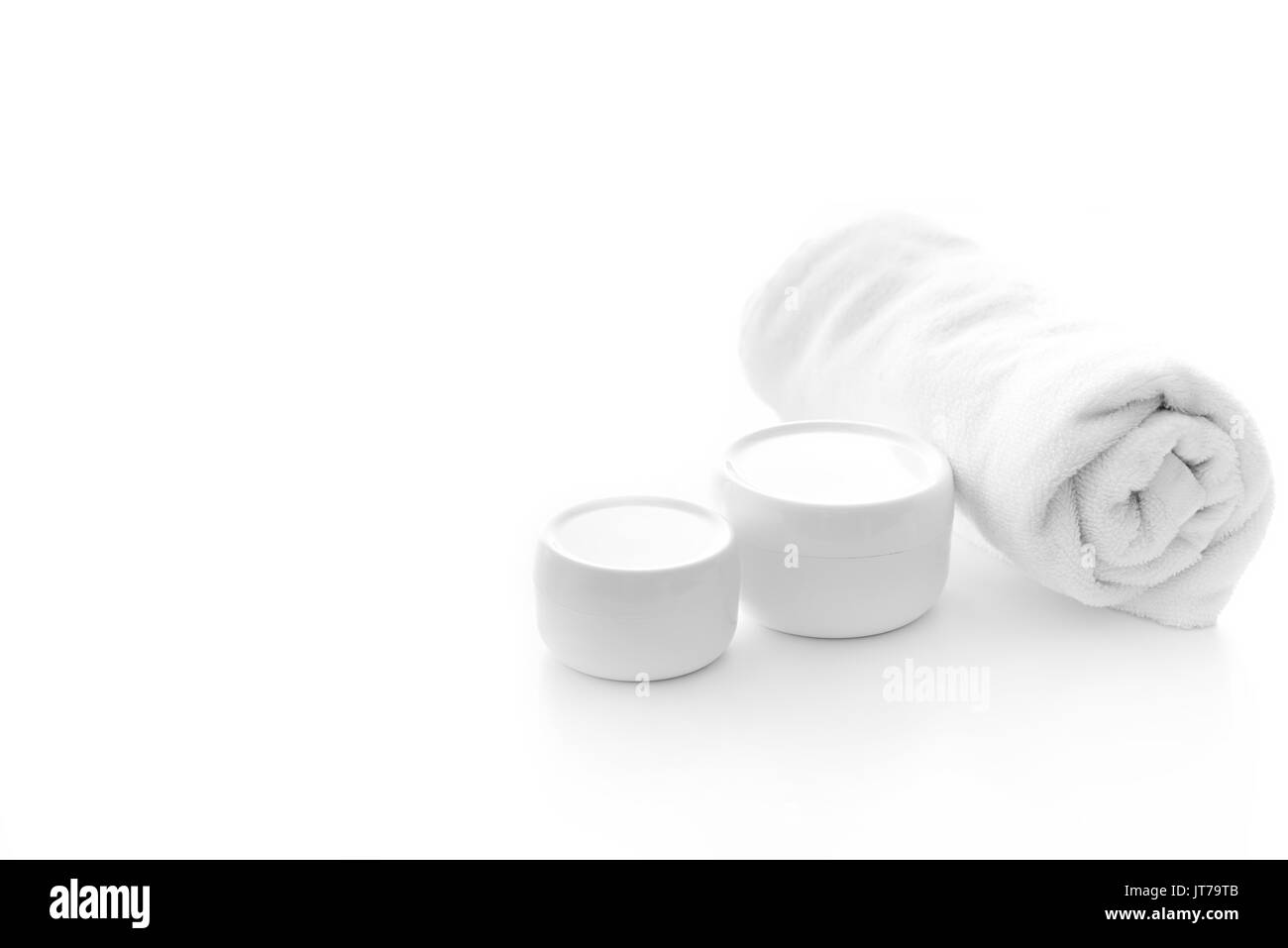 different skin cream or body lotion and towel isolated on white Stock ...