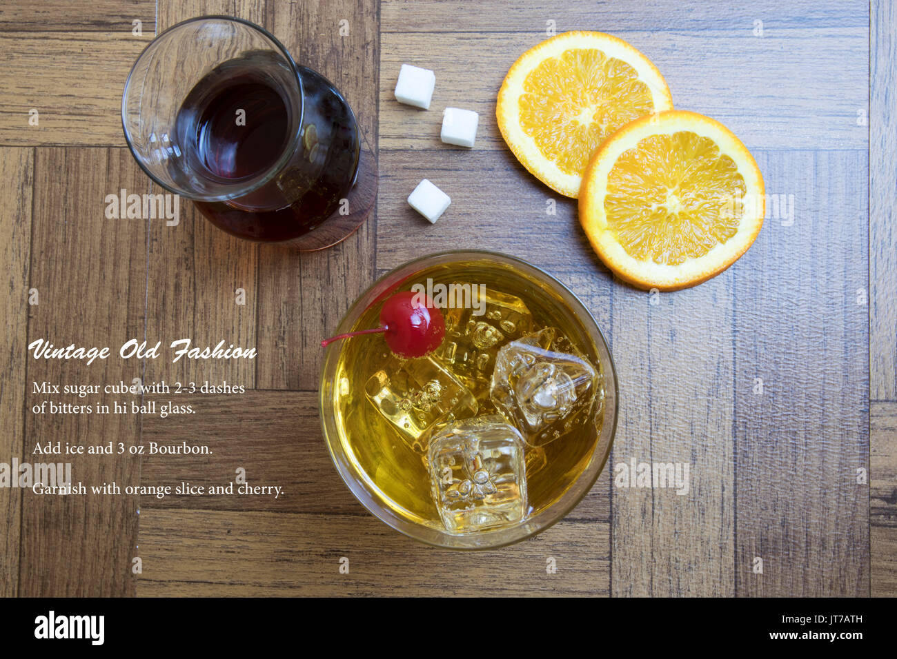 Classic Old Fashion bourbon cocktail on rocks garnished with cherry and ...