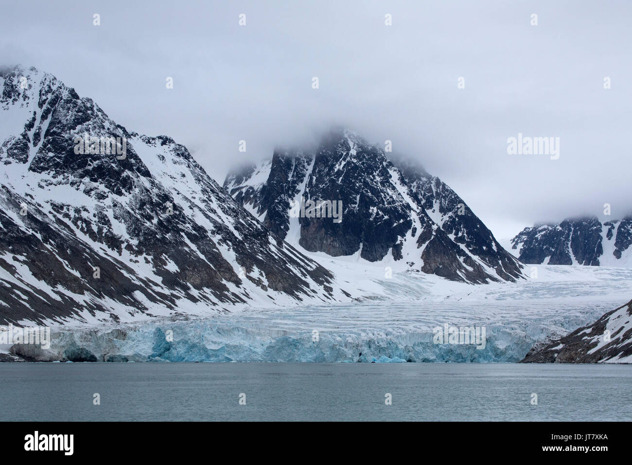 Snow covered mountains and glacier. Taken in June, Magdalenefjord ...