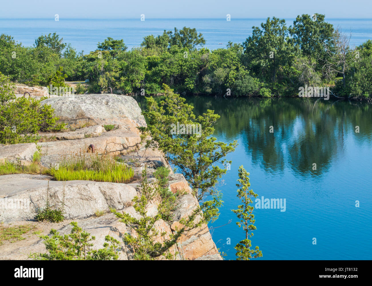 view of Atlantic ocean and water filled granite quarry in Massachusetts ...