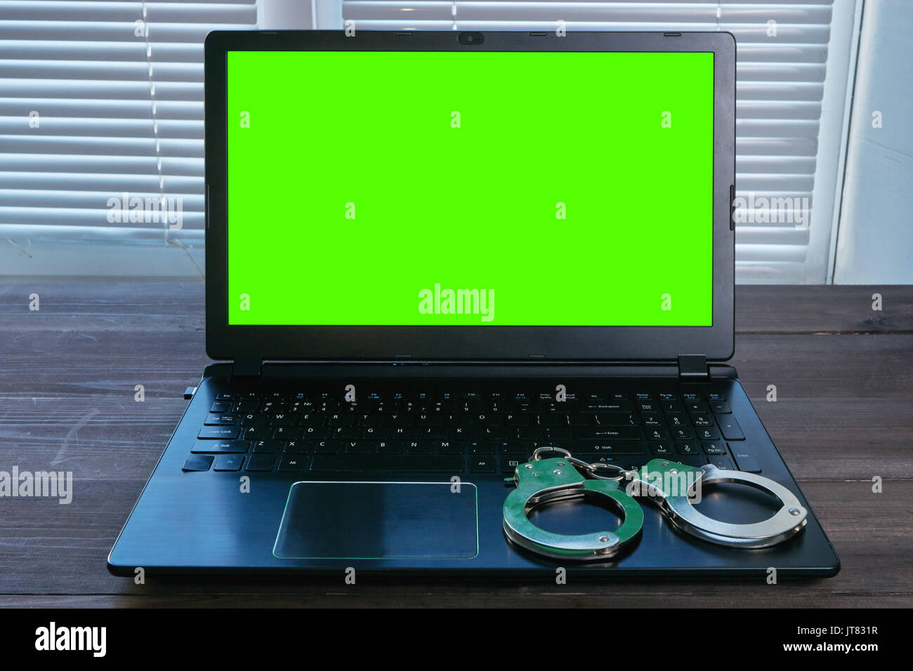 concept image of computer crime, high tech criminal hacker. handcuffs ...