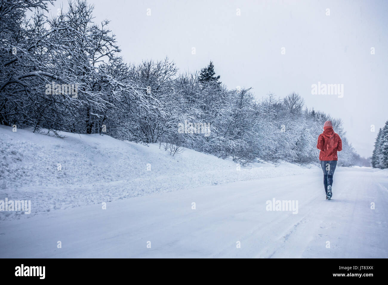 Woman Running Alone with Motion Blur during Cold Snowy day of Winter in ...