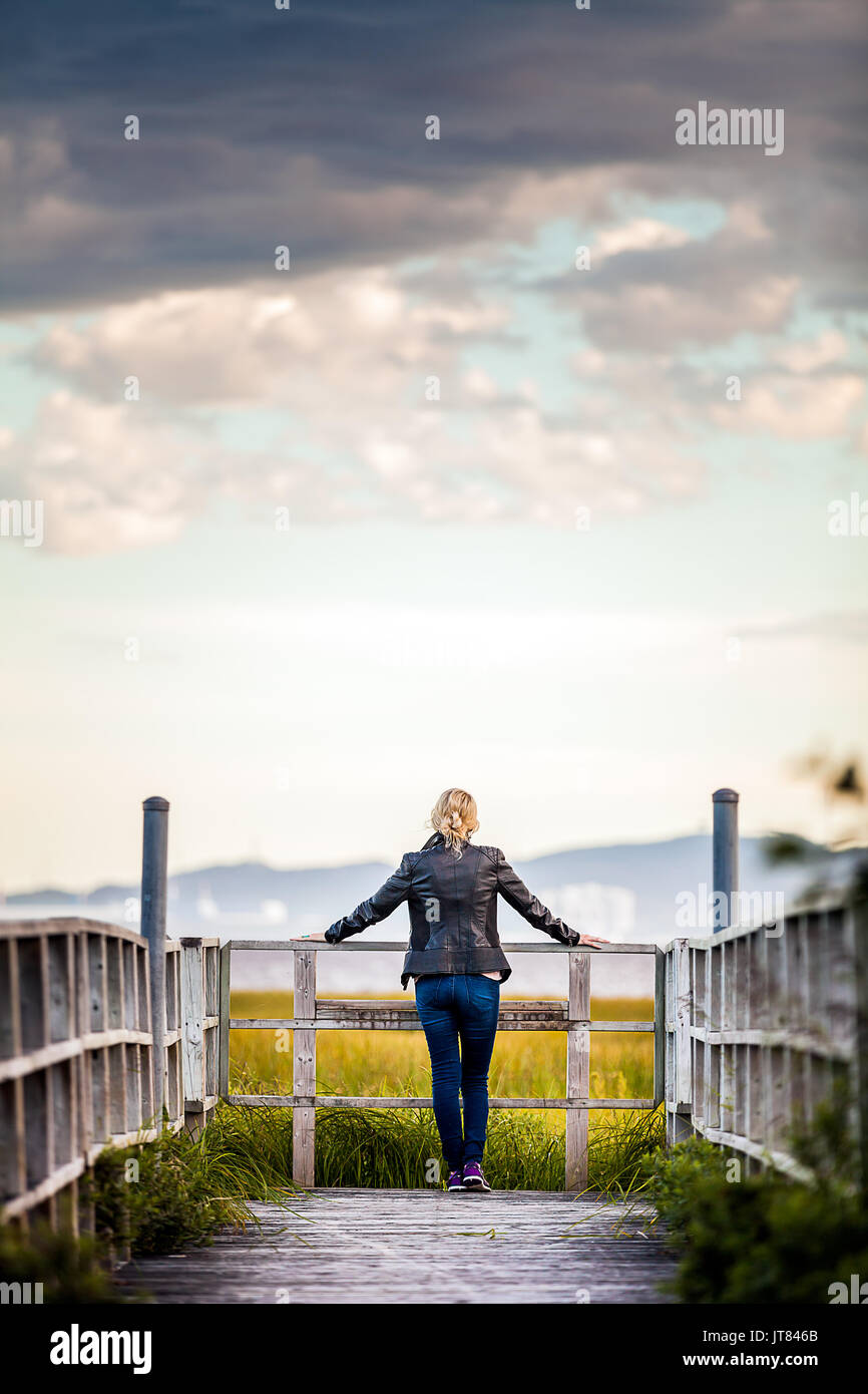 Girl looking out from balcony hi-res stock photography and images - Alamy