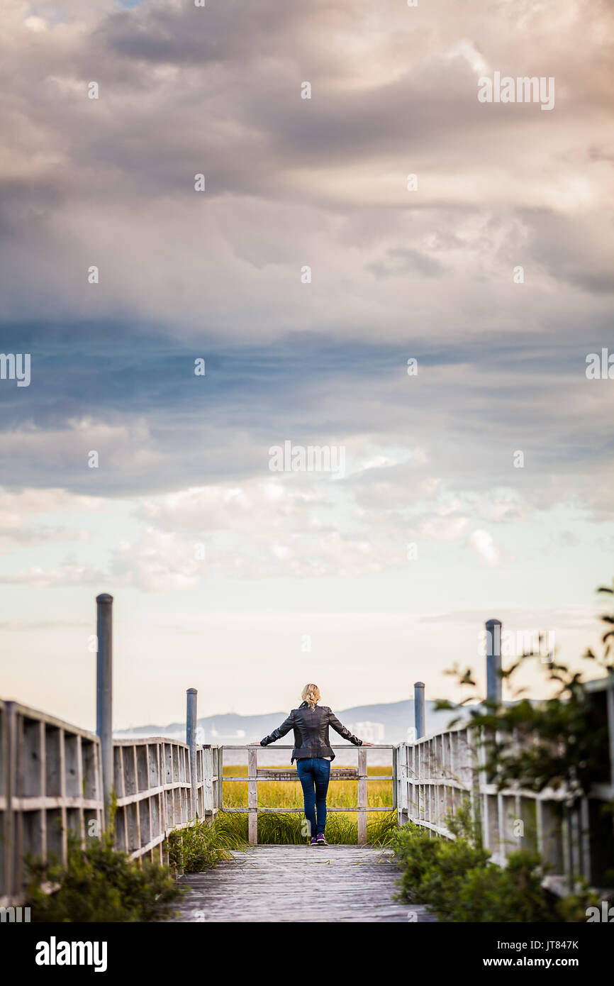 Girl looking out from balcony hi-res stock photography and images - Alamy