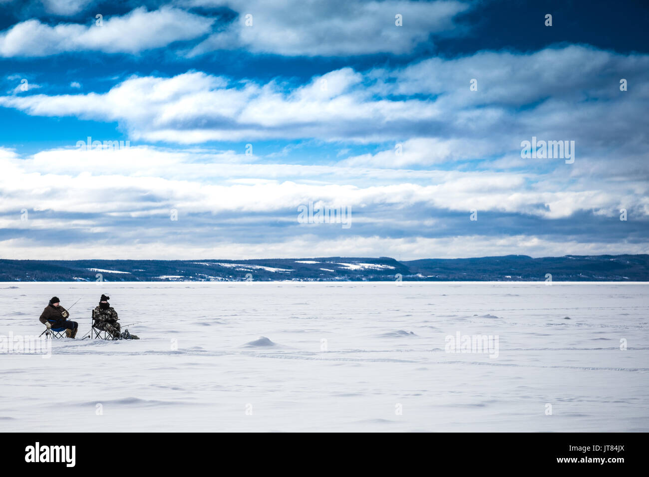 Miguasha, Canada - January 22, 2017. Two Random People Fishing on ice ...