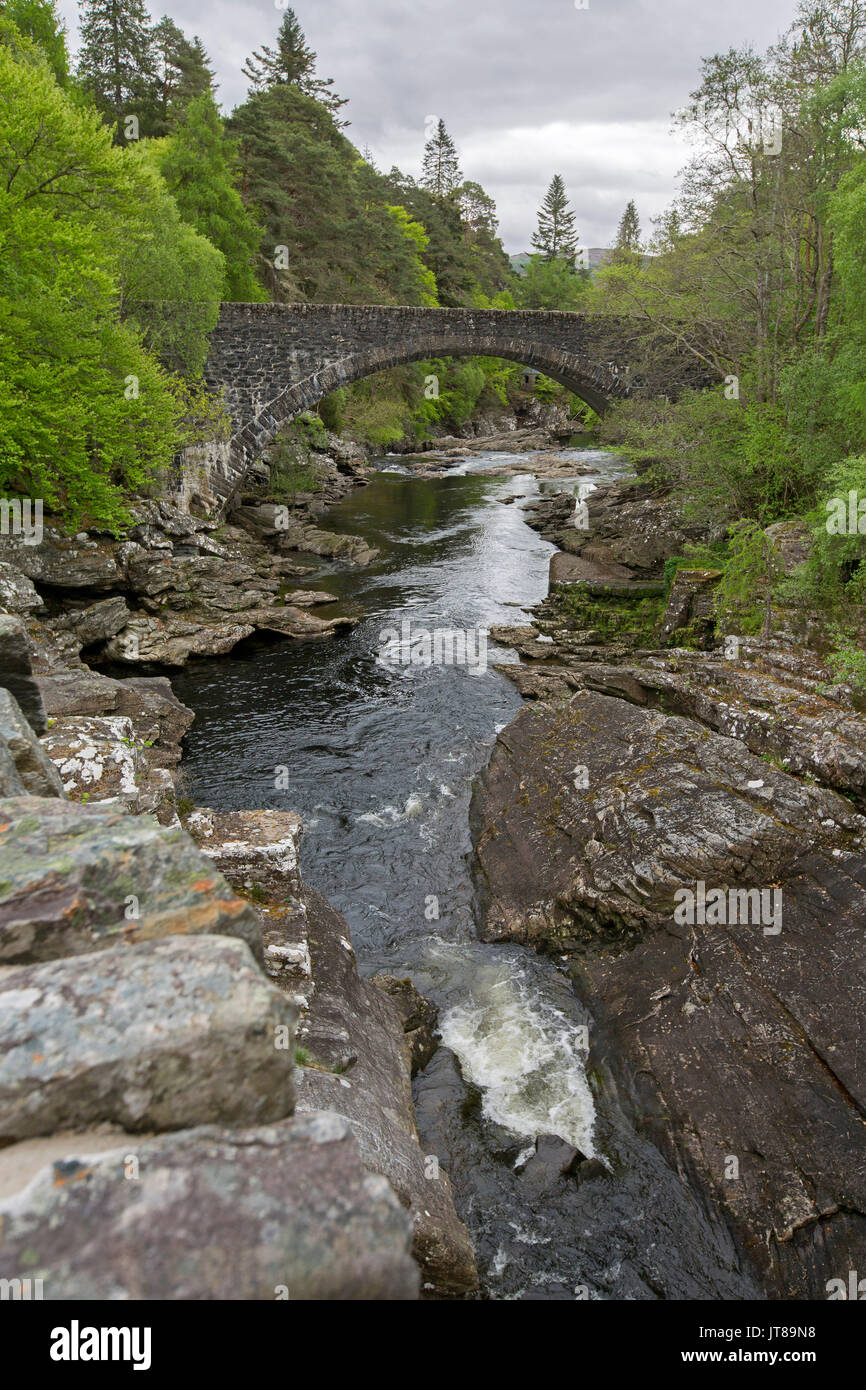 Historic arched stone bridge spanning River Moriston as it mutters ...