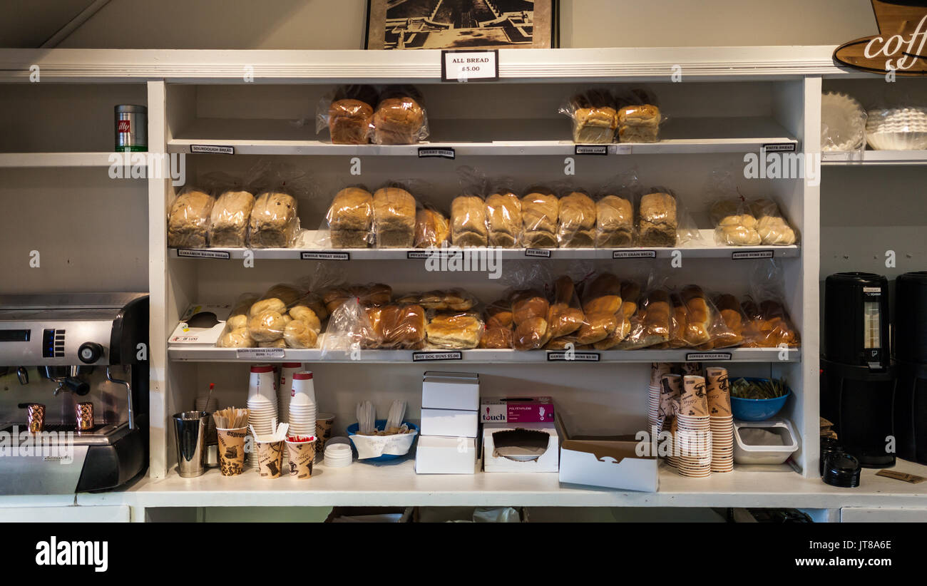 A colour horizontal picture inside a small town bakery with shelves ...