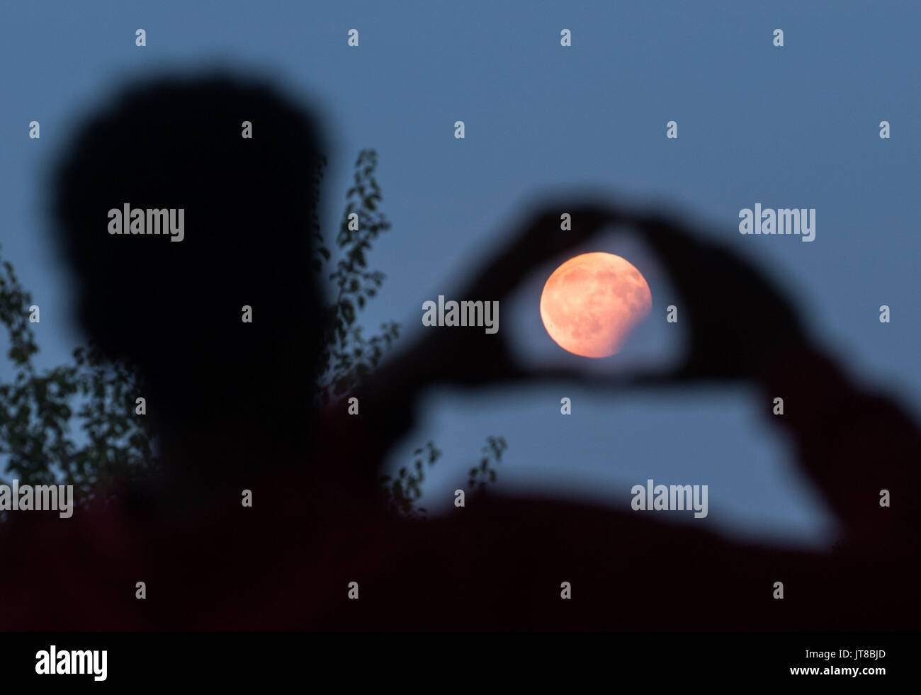 Berlin, Germany. 07th Aug, 2017. dpatop - Glance at a partial moon eclipse in Berlin, Germany ...