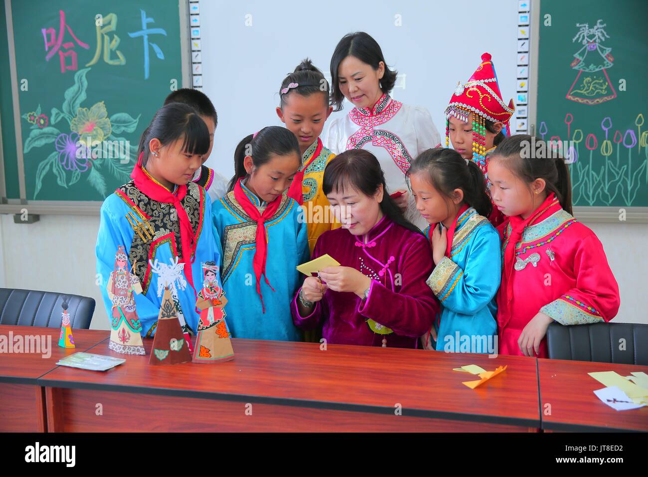 Hohhot. 8th Aug, 2017. Pupils learn to make a traditional toy of Daur ...