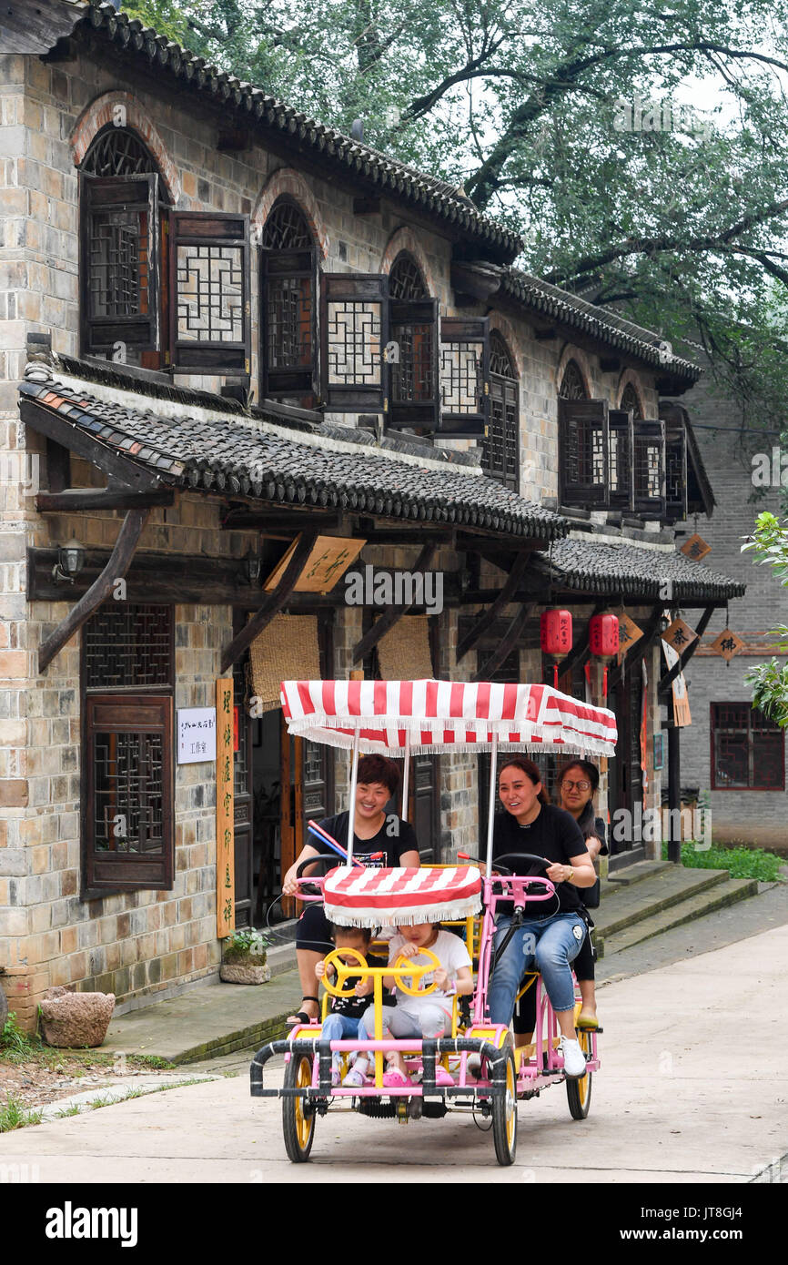 (170808) -- XINYANG, Aug. 8, 2017 (Xinhua) -- Tourists cycle in Haotang ...