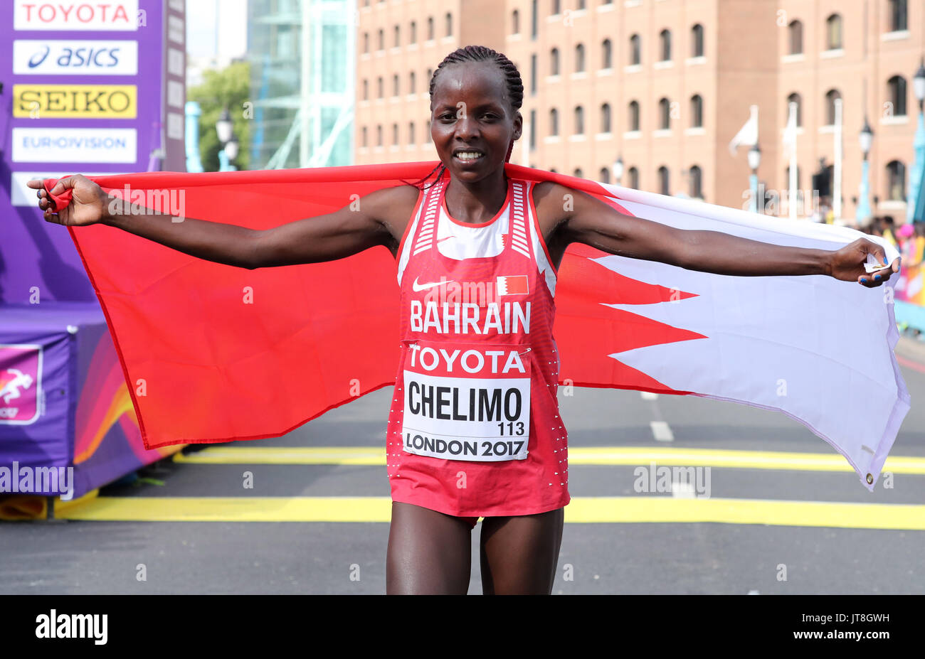 Rose Chelimo (BRN) poses with Bahrain flag after winning the women's ...