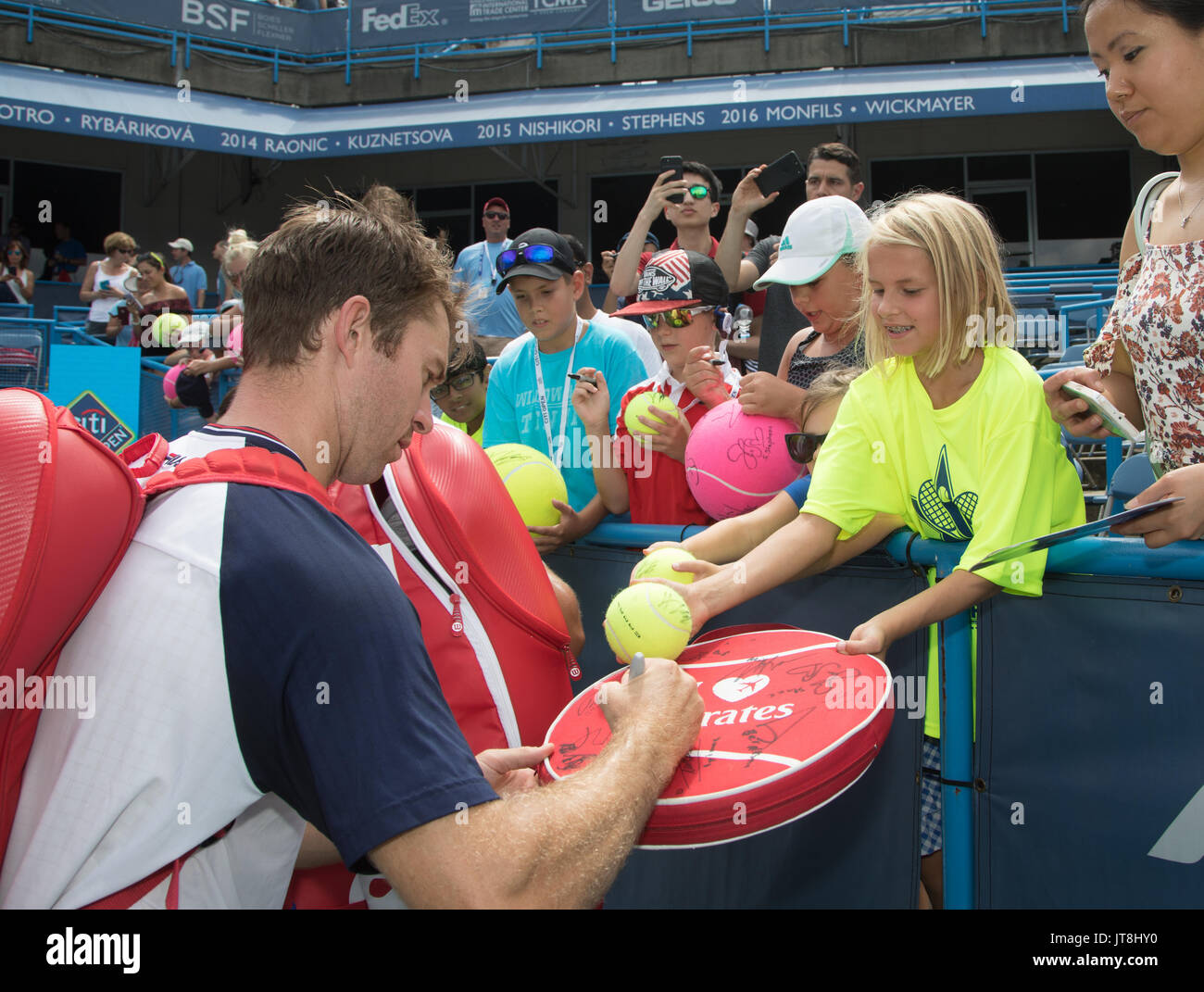 Fans collect autographs from John Peers of Australia who with Henri ...