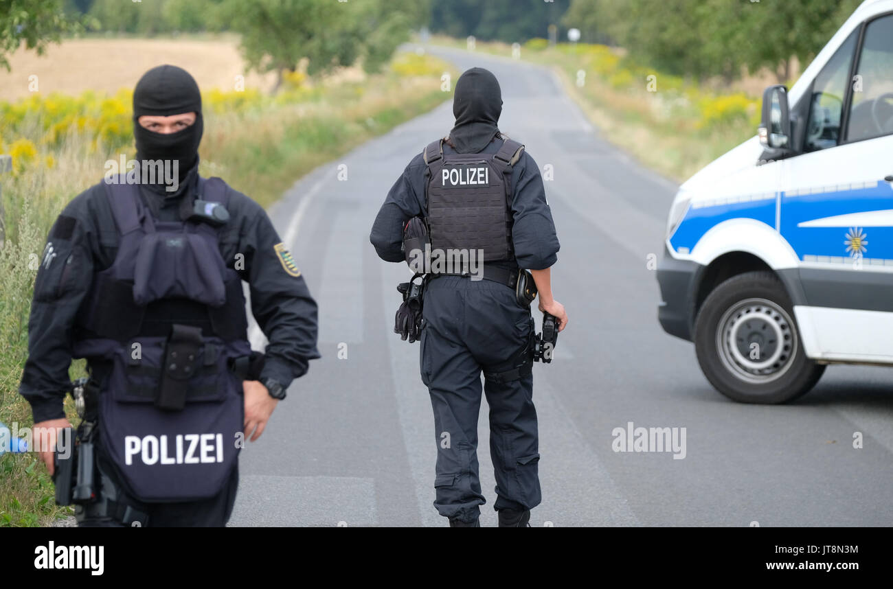 Police officers block a road in the Merkwitz area of Taucha, Germany, 8 ...