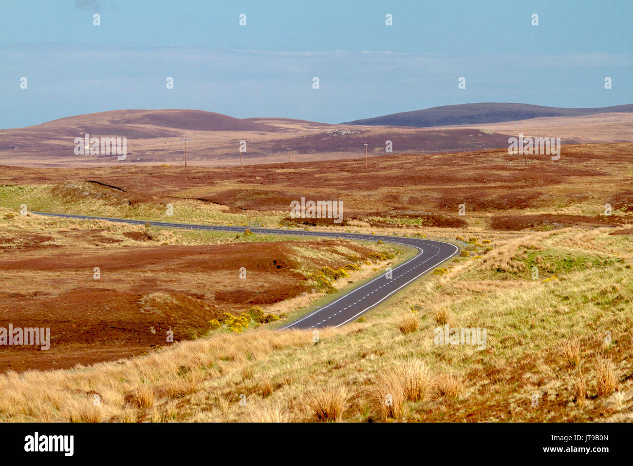 Landscape of vast golden moors in highlands of Scotland with narrow ...