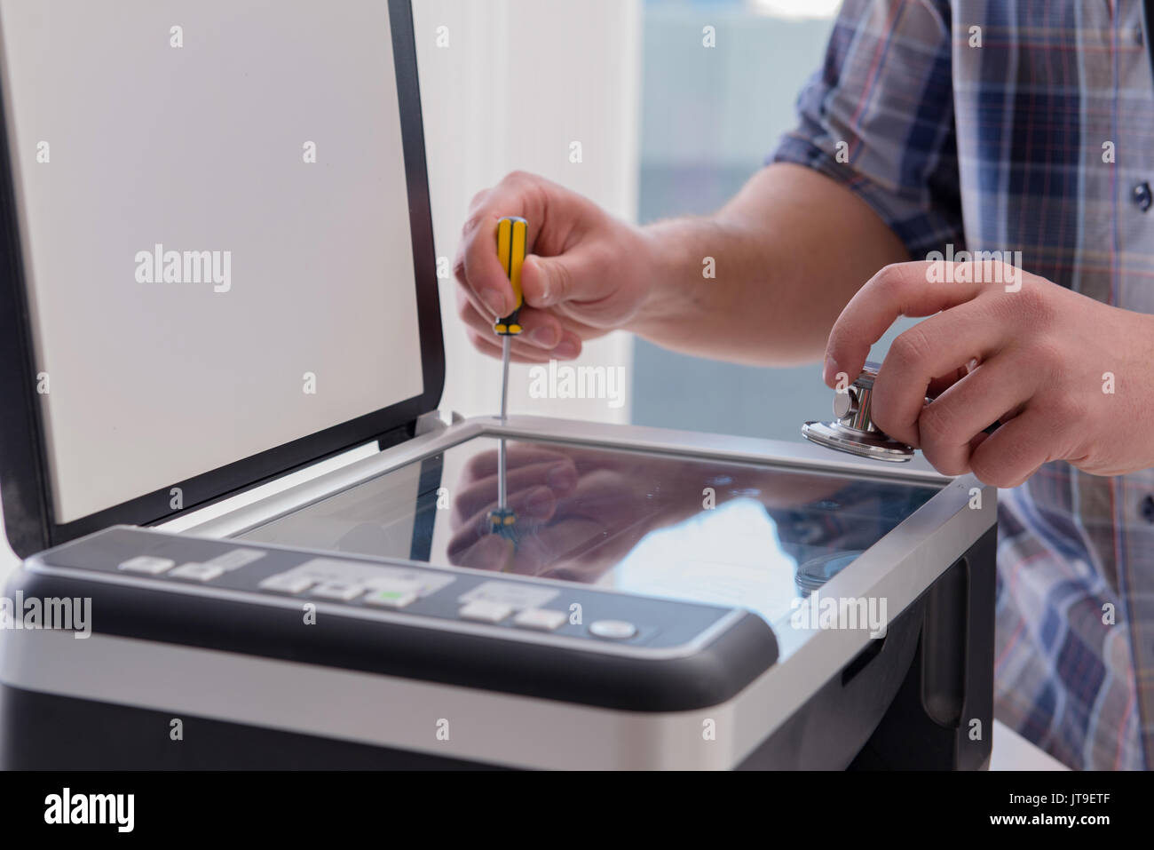 Repairman repairing broken color printer Stock Photo - Alamy