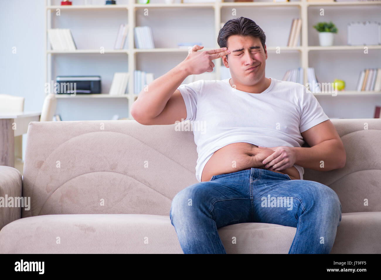 Man suffering from extra weight in diet concept Stock Photo - Alamy