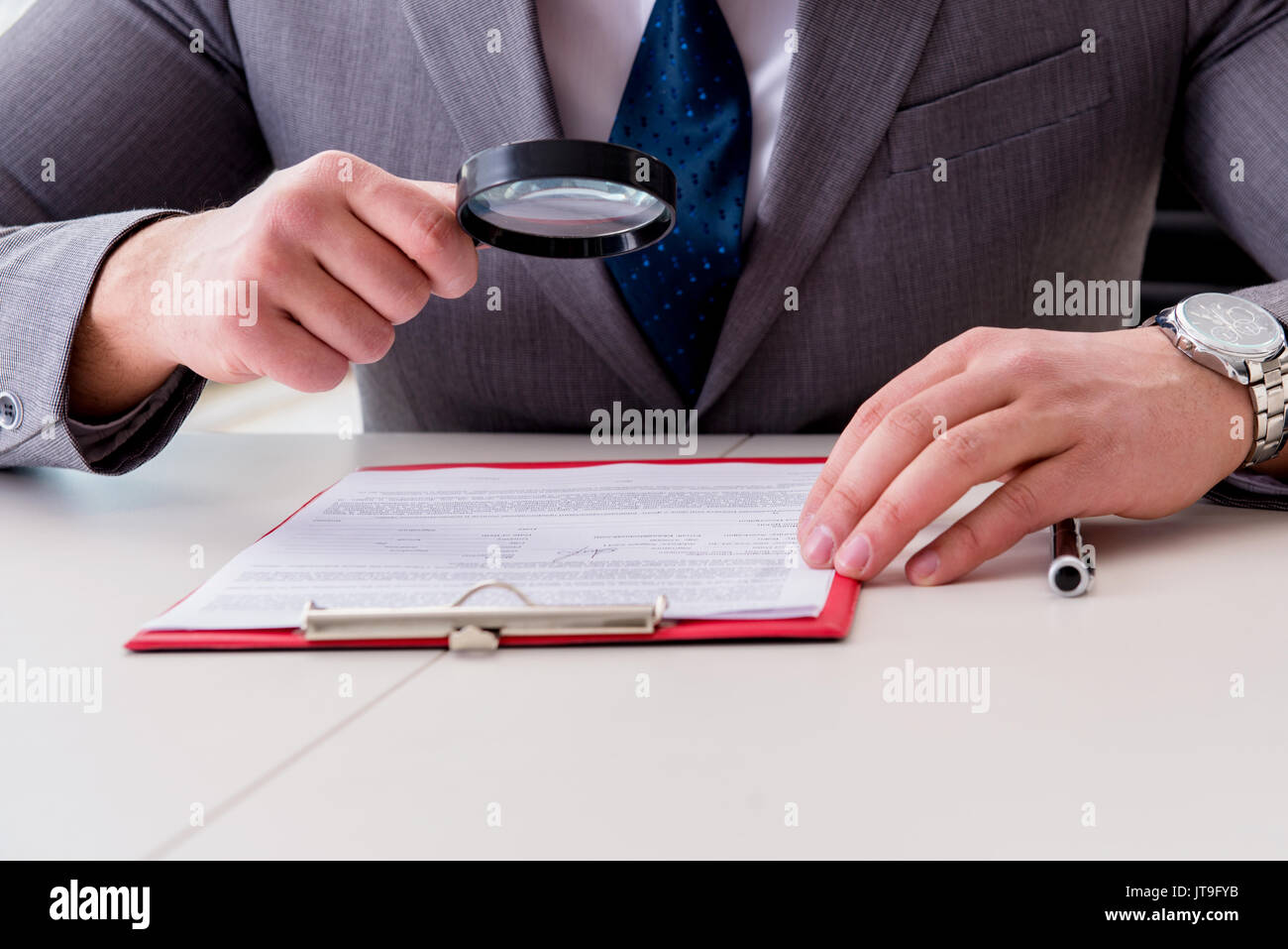 Man looking for errors and mistakes in report Stock Photo - Alamy