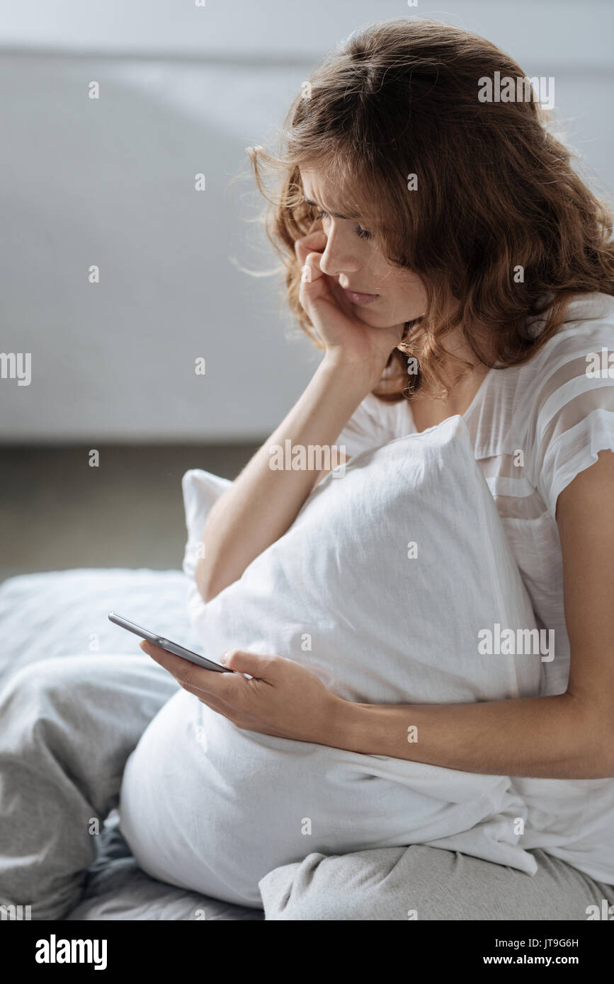 Sad young woman holding her chin Stock Photo - Alamy