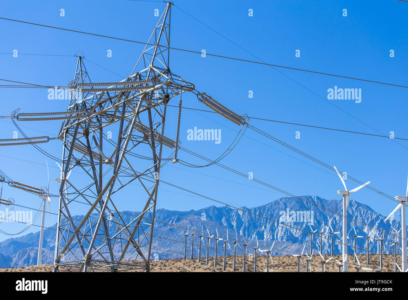 Wind turbine with power grid towers Stock Photo - Alamy