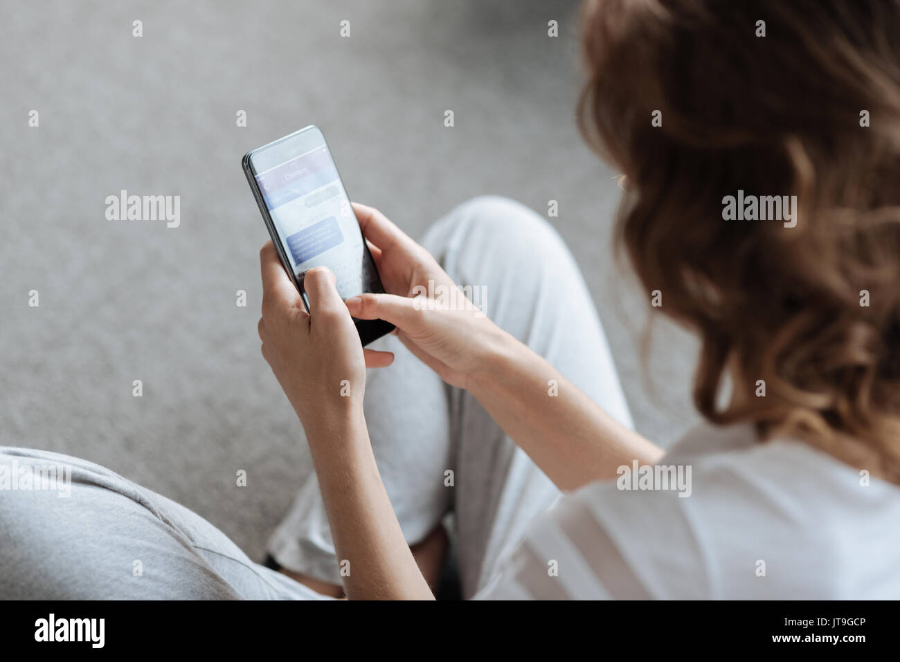 Nice pleasant woman reading a message Stock Photo - Alamy