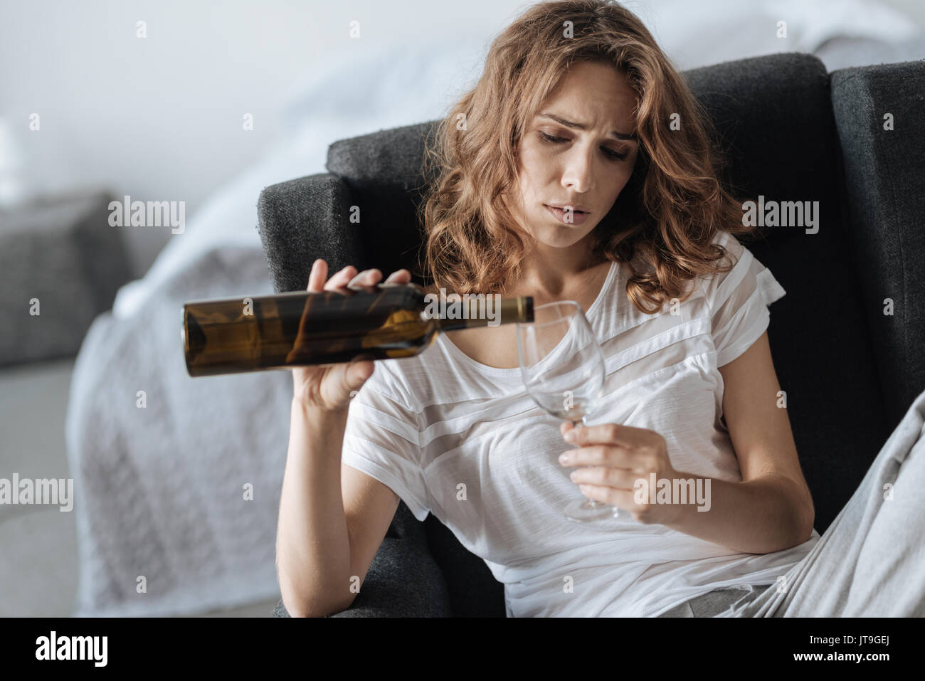 Depressed cheerless woman drinking alcohol Stock Photo - Alamy