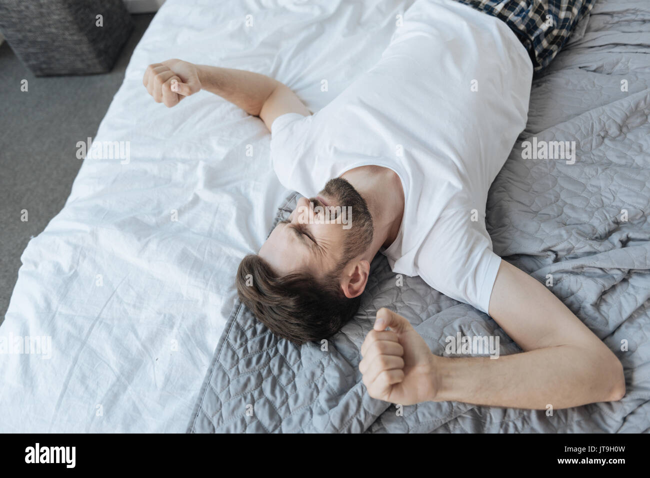 Handsome sleepy man stretching himself Stock Photo - Alamy