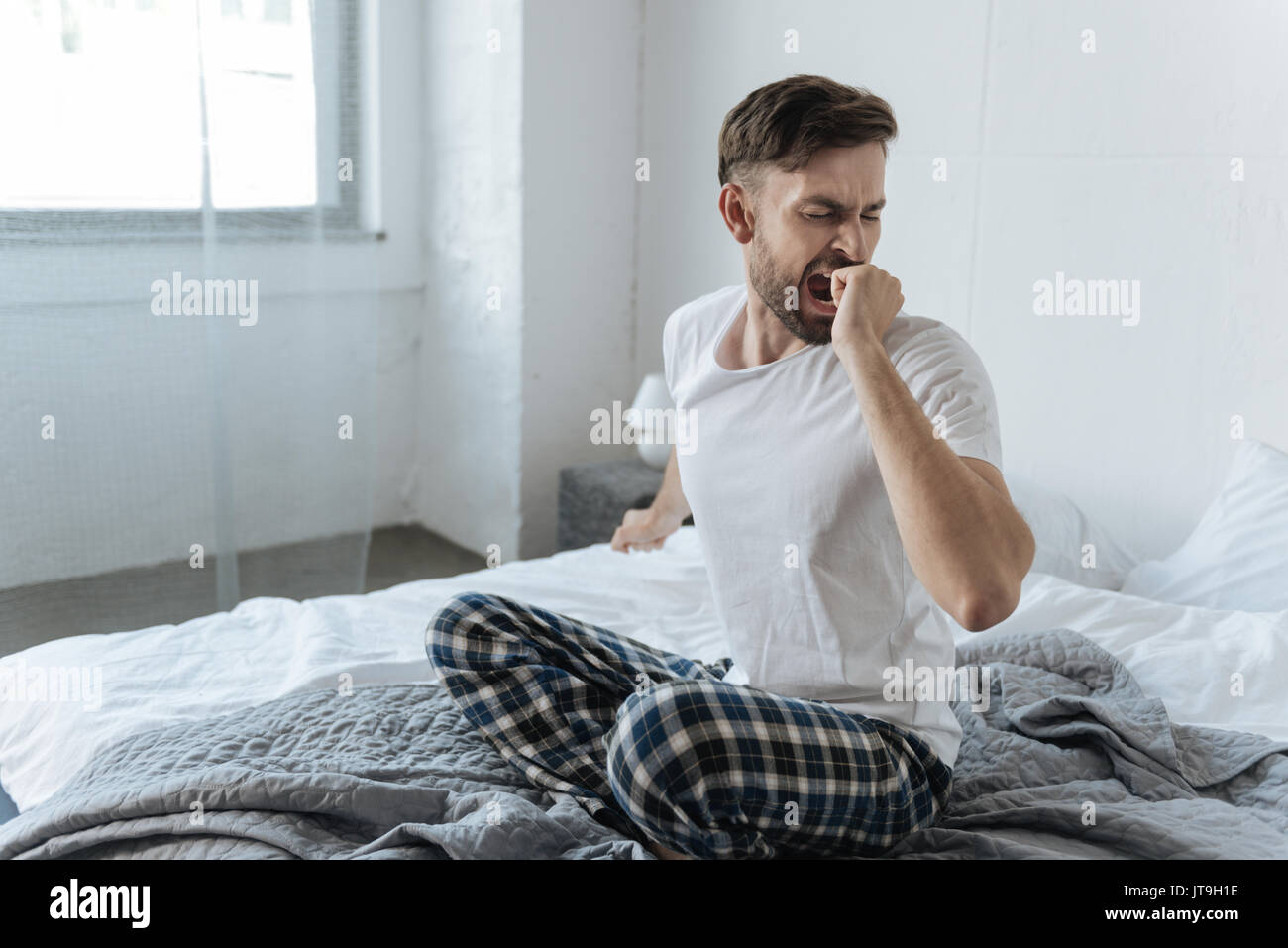 Sleepy man yawning stretching hi-res stock photography and images - Alamy