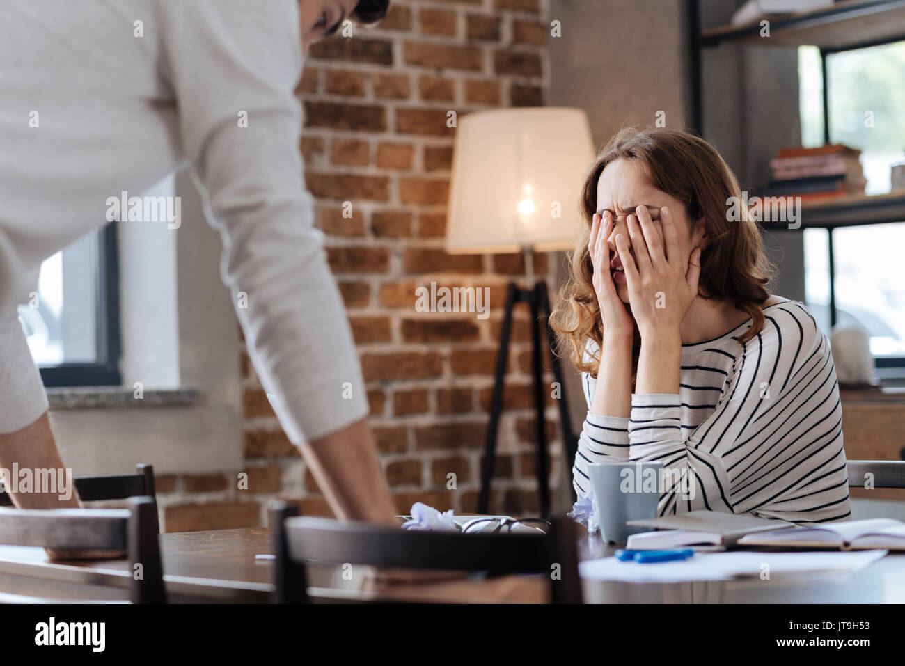 Cheerless young woman covering her face Stock Photo - Alamy