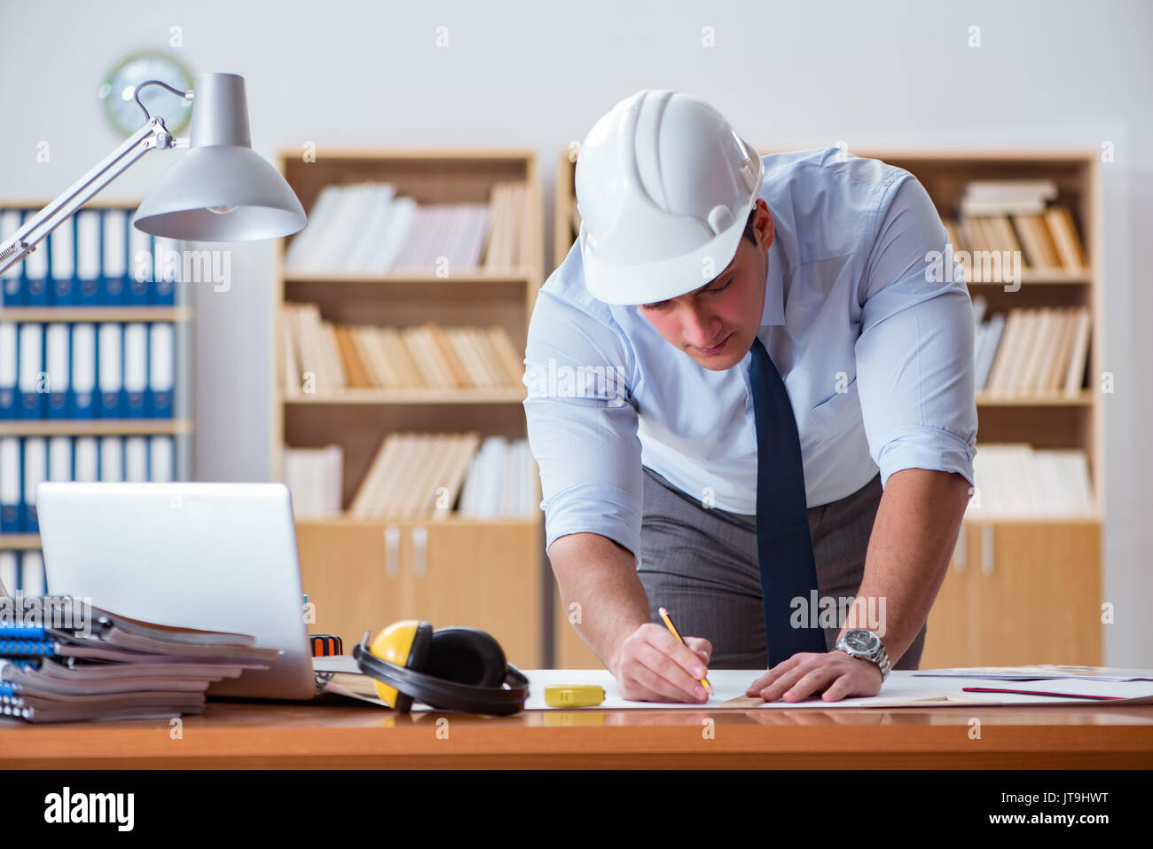 Engineer supervisor working on drawings in the office Stock Photo - Alamy