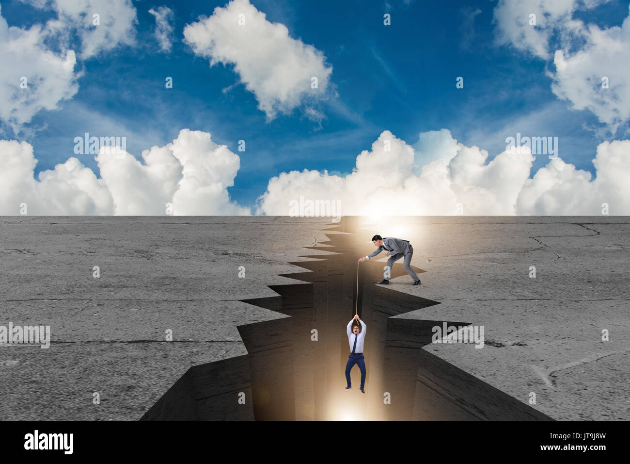 Man saving colleague pulling rope Stock Photo - Alamy