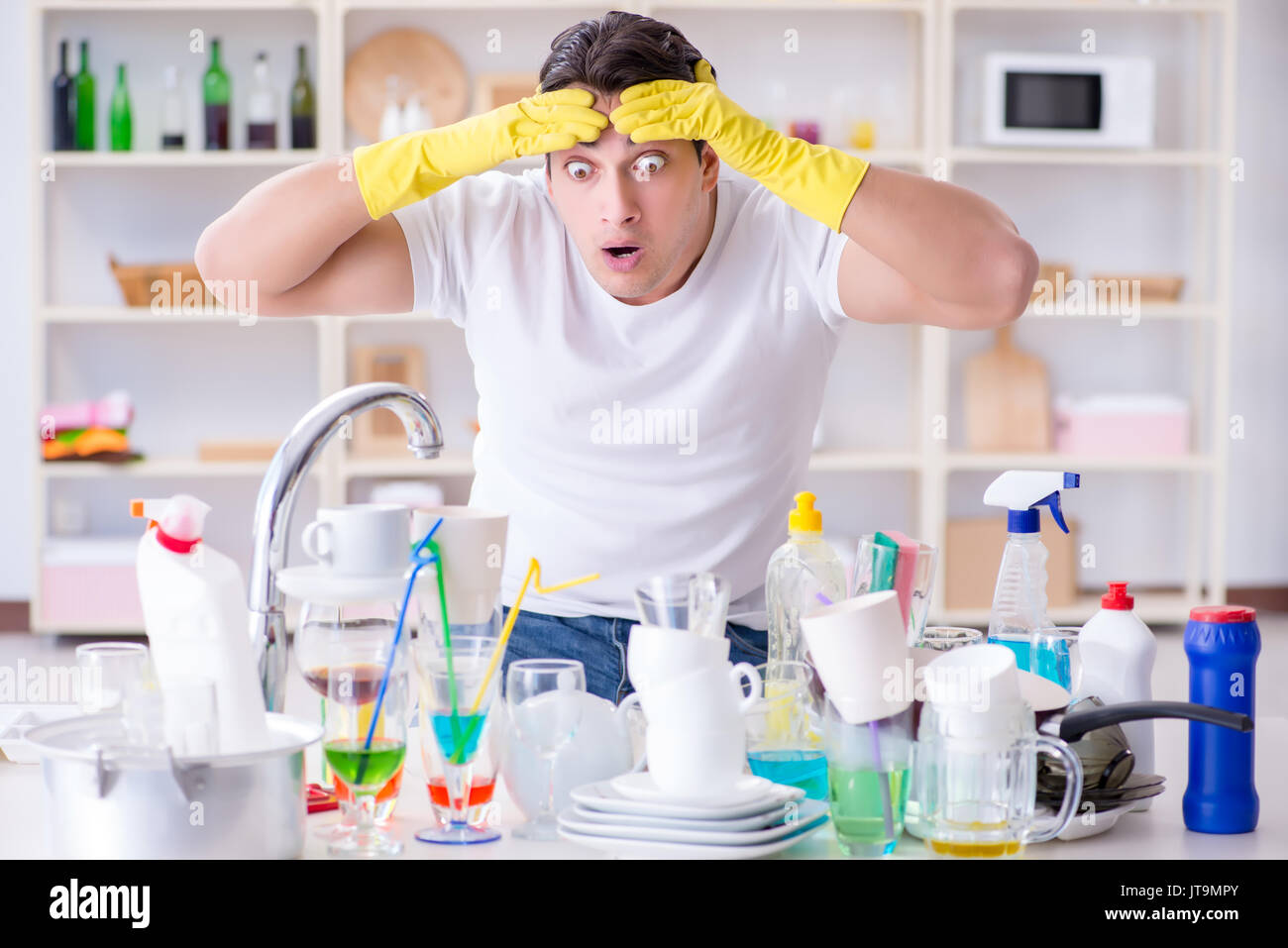 Man frustrated at having to wash dishes Stock Photo - Alamy