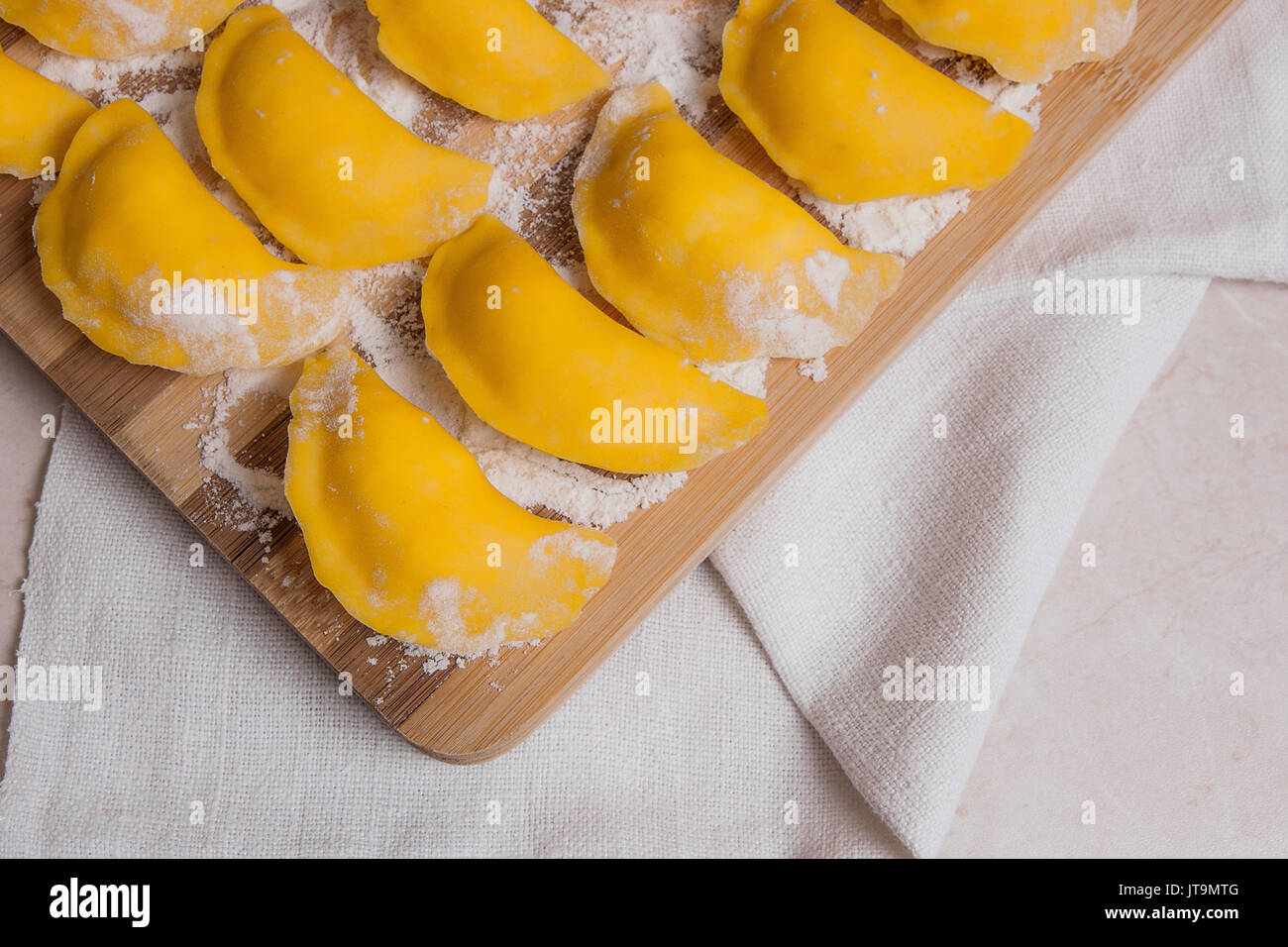 Several ready for boiling vareniki, dumplings, pierogi with cottage ...
