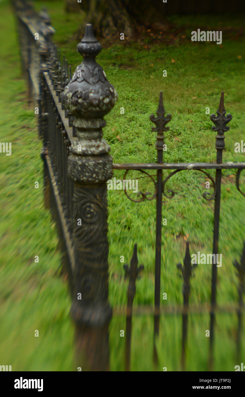 vintage iron fence posts weather mossy Stock Photo - Alamy