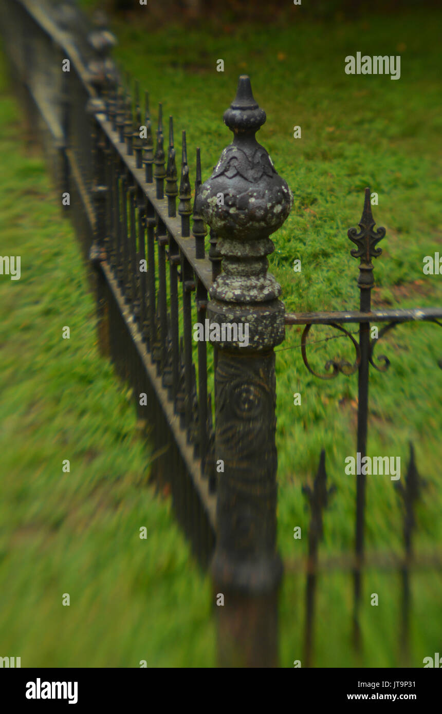 vintage iron fence posts weather mossy Stock Photo - Alamy