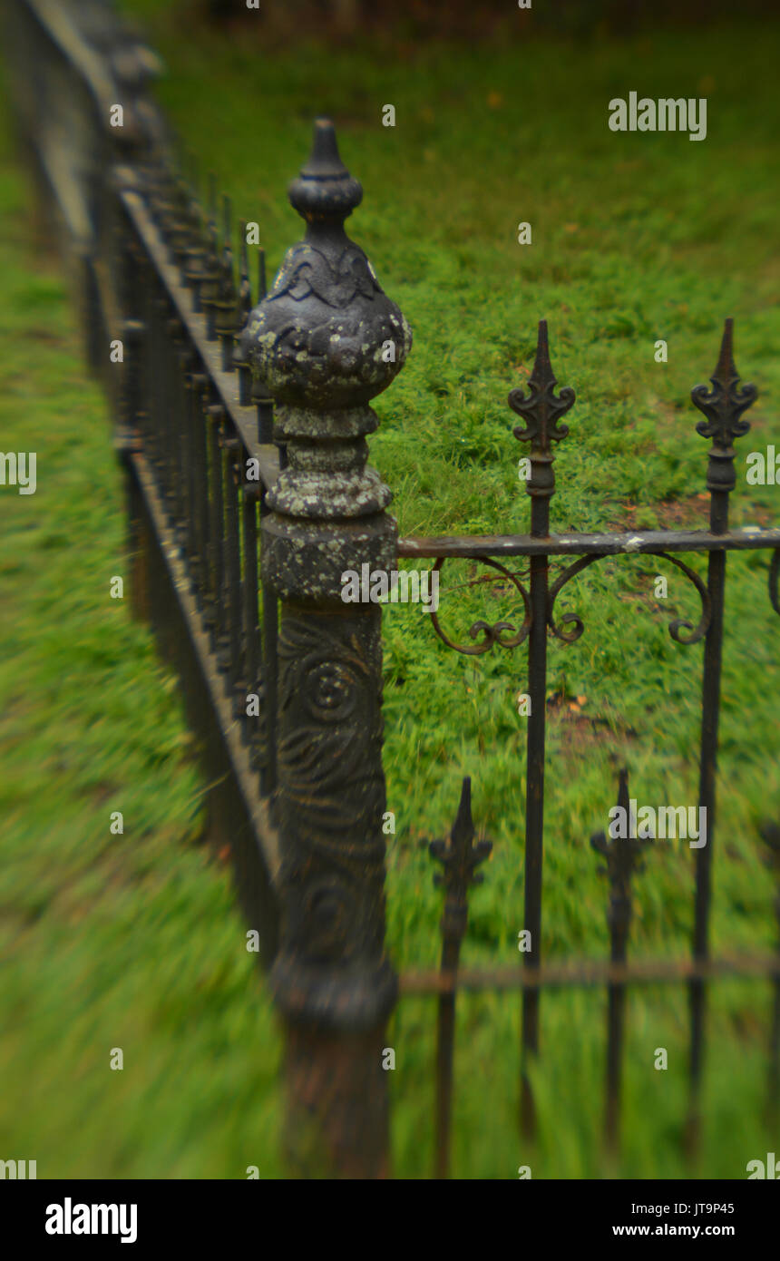 vintage iron fence posts weather mossy Stock Photo - Alamy
