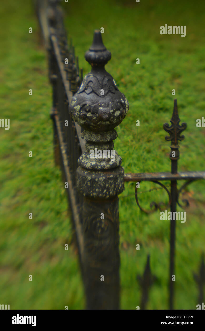 vintage iron fence posts weather mossy Stock Photo - Alamy