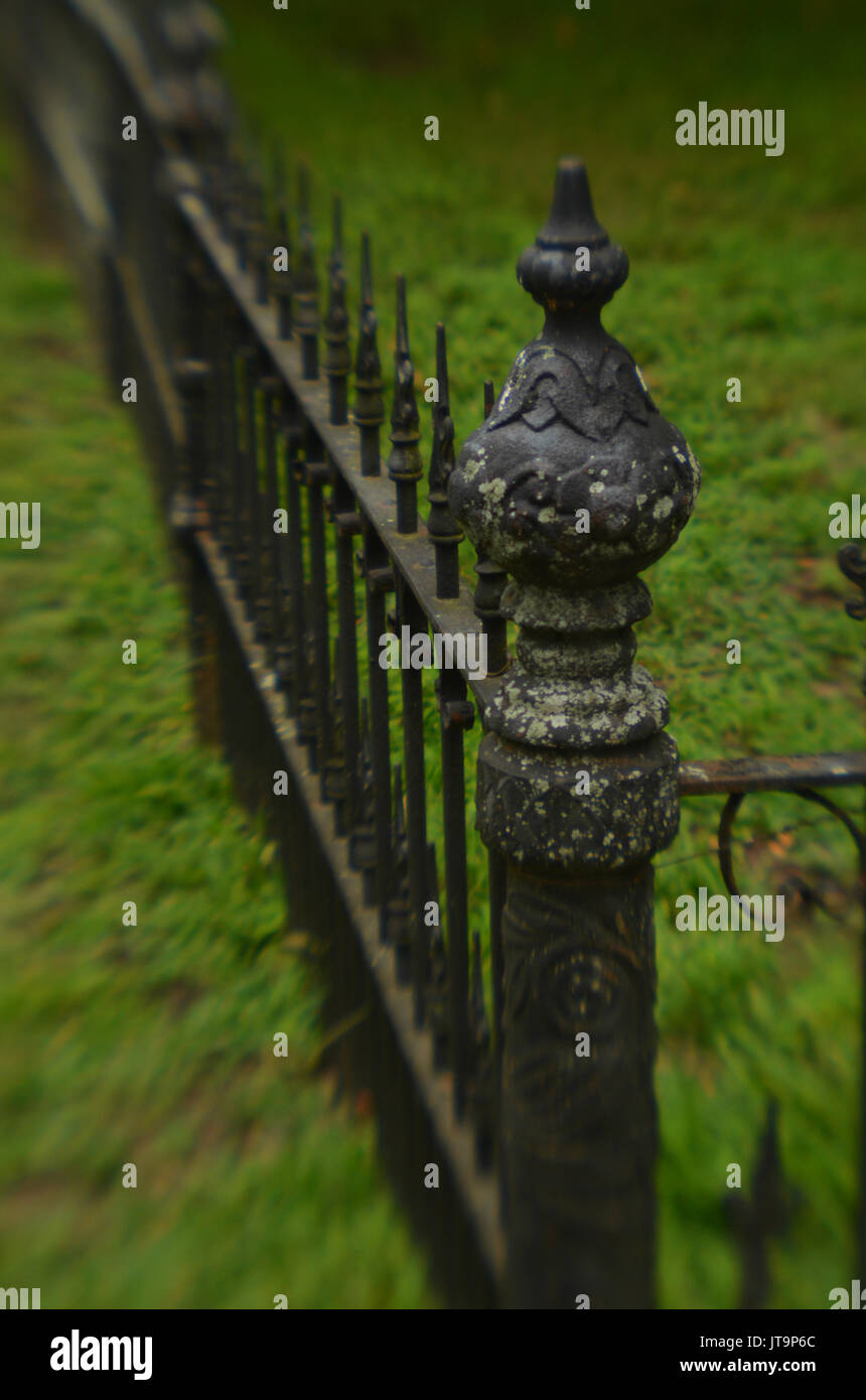 vintage iron fence posts weather mossy Stock Photo - Alamy