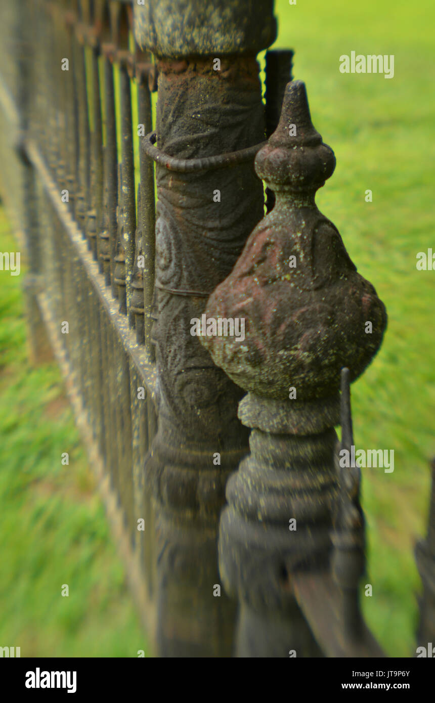 vintage iron fence posts weather mossy Stock Photo - Alamy