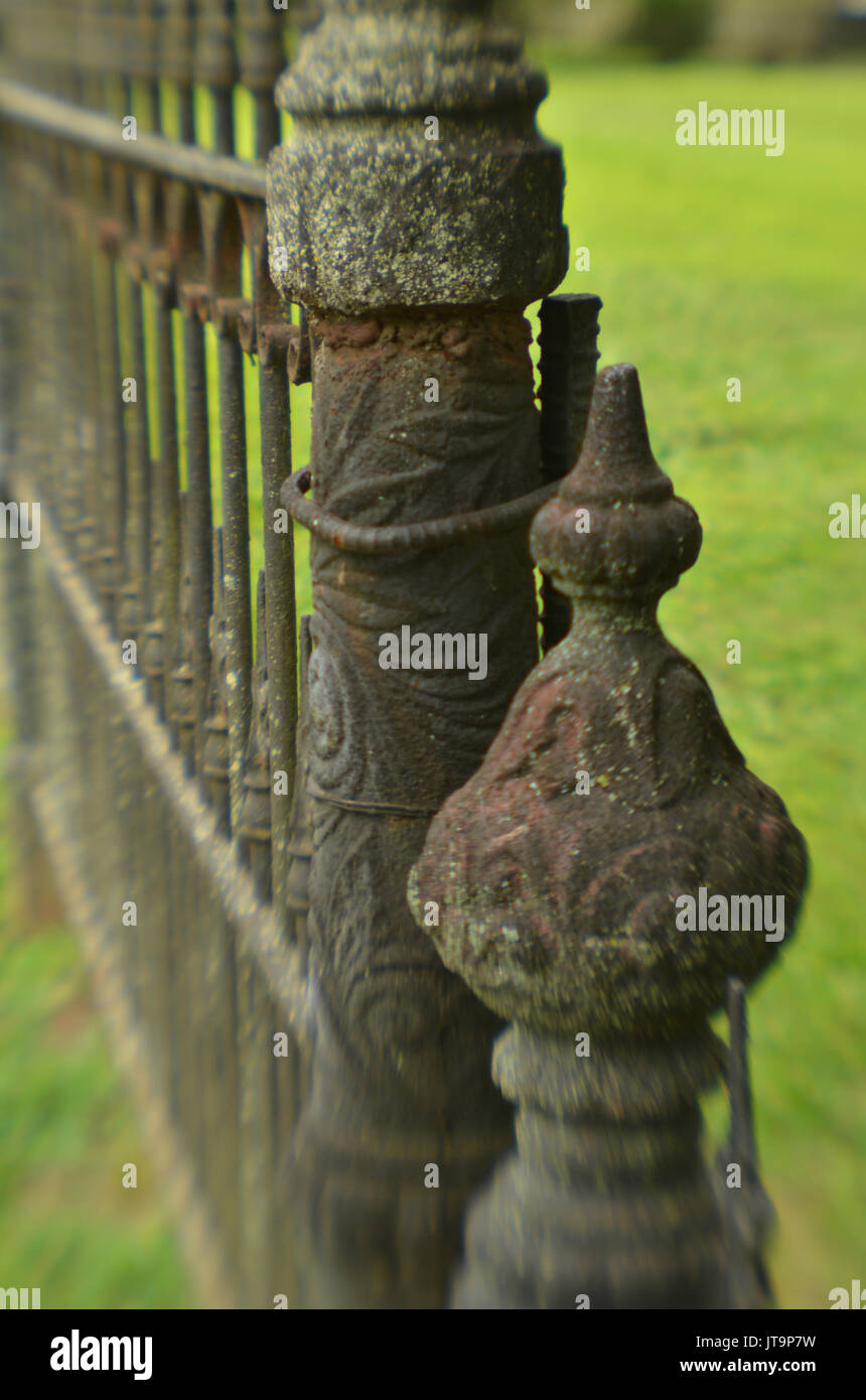 vintage iron fence posts weather mossy Stock Photo - Alamy