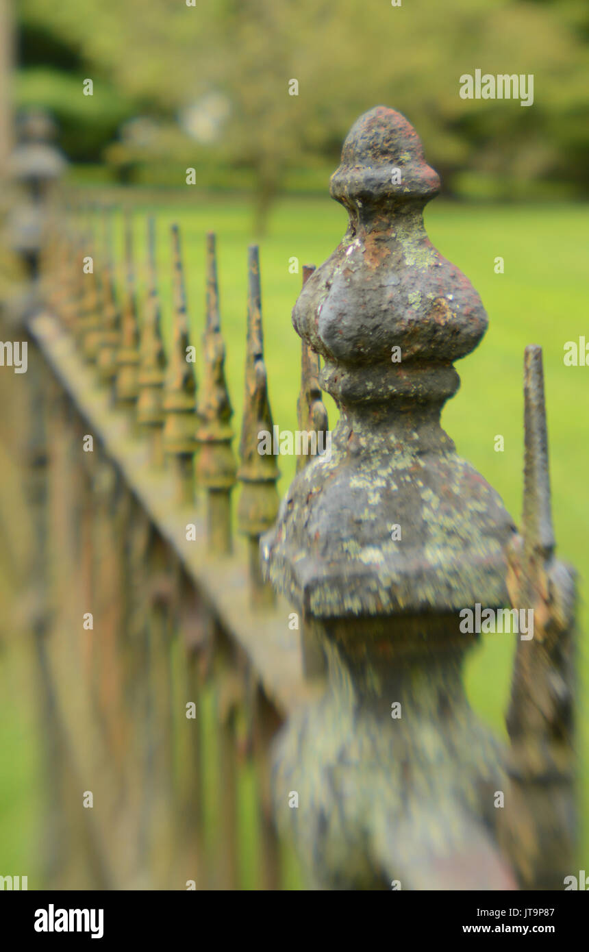 vintage iron fence posts weather mossy Stock Photo - Alamy