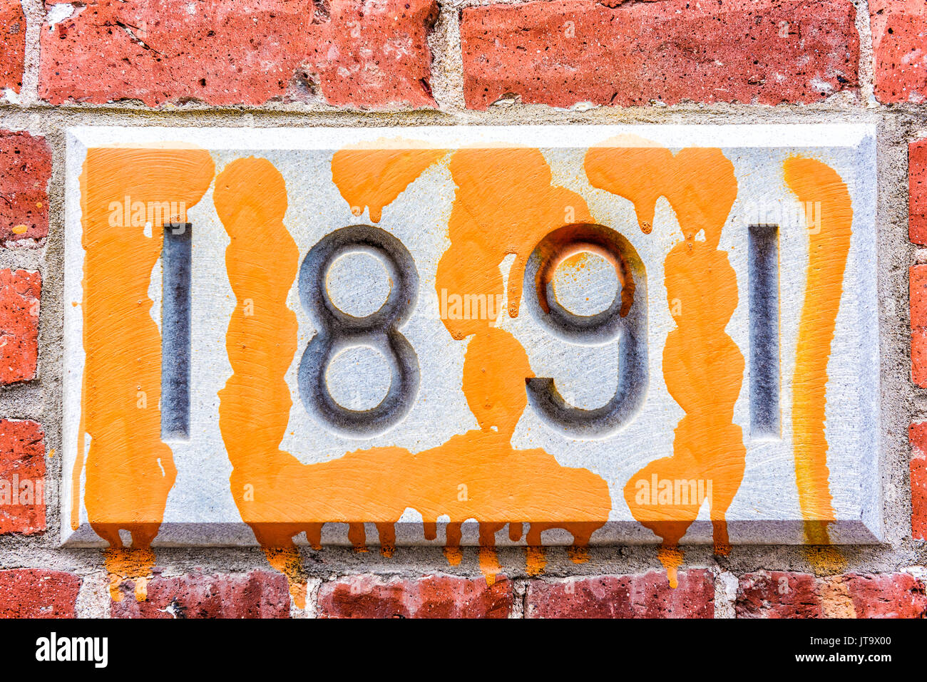 Closeup of 1891 number sign on brick building with colorful paint Stock ...