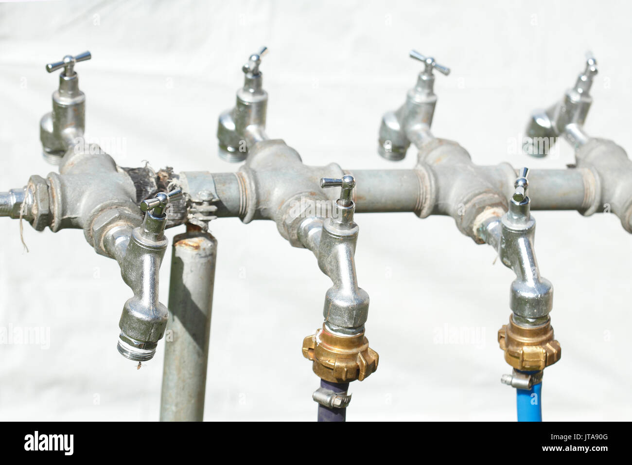 silver metal outside water taps with multiple connection Stock Photo ...