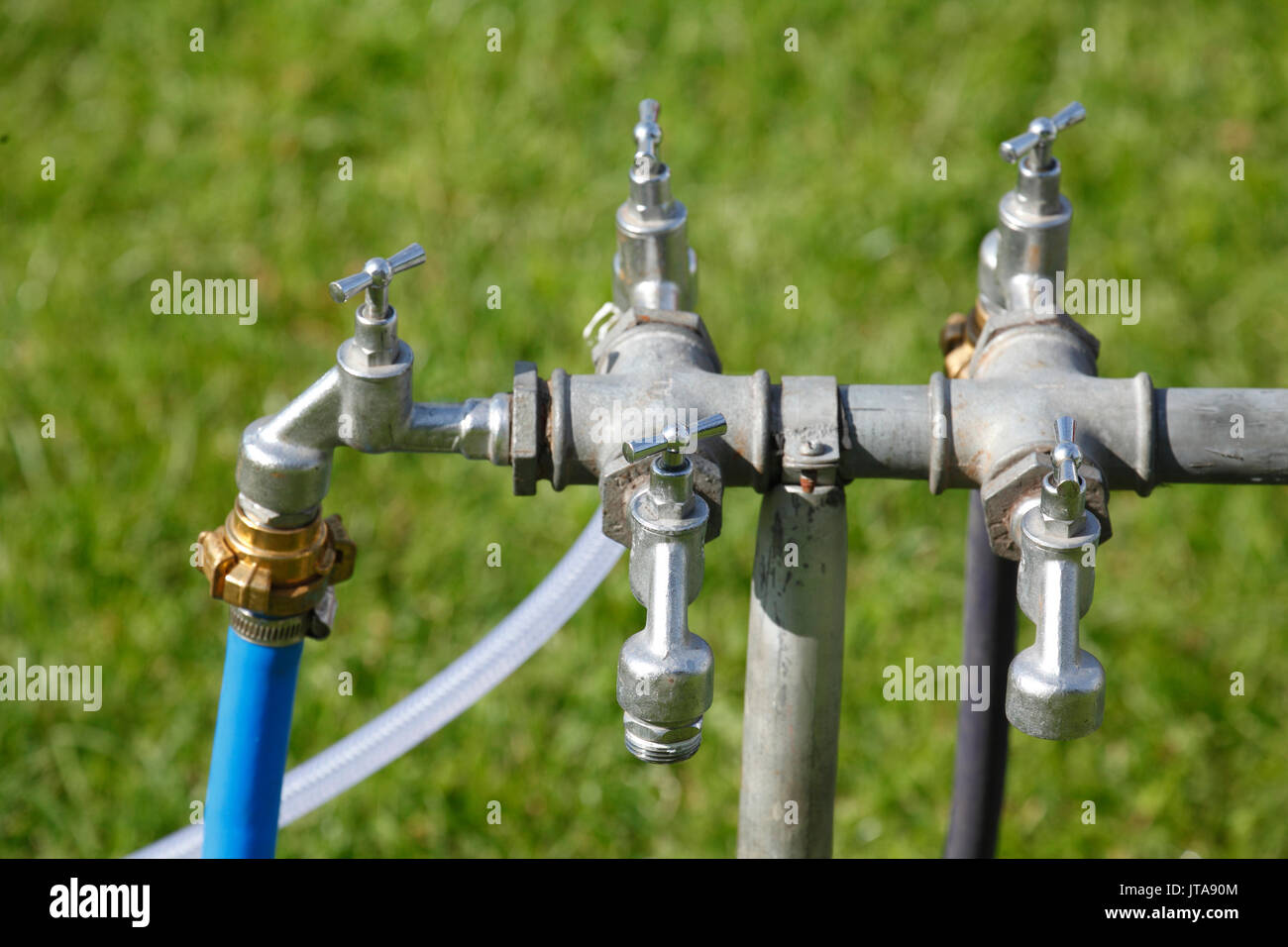 silver metal outside water taps with multiple connection Stock Photo ...