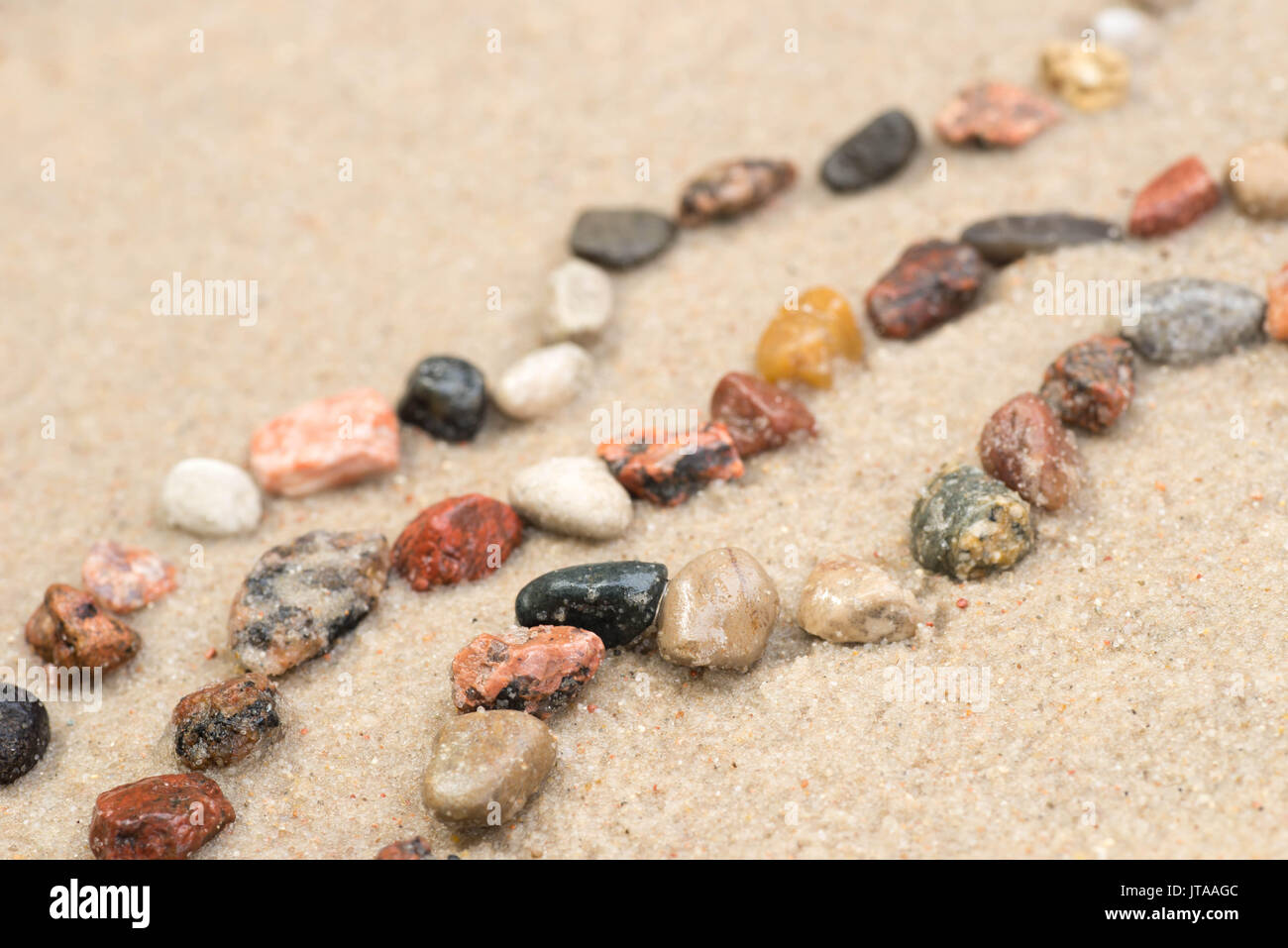 pebble wave pattern on sand background selective focus Stock Photo - Alamy