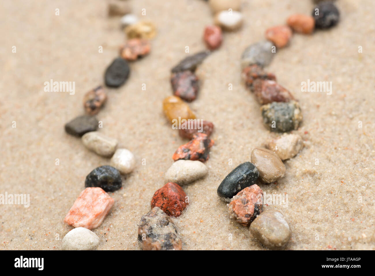 pebble wave pattern on sand background selective focus Stock Photo - Alamy