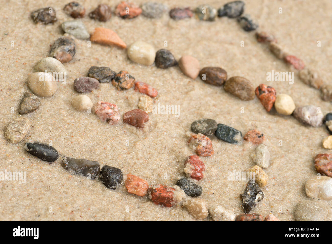 pebble house shape on sand background selective focus Stock Photo - Alamy