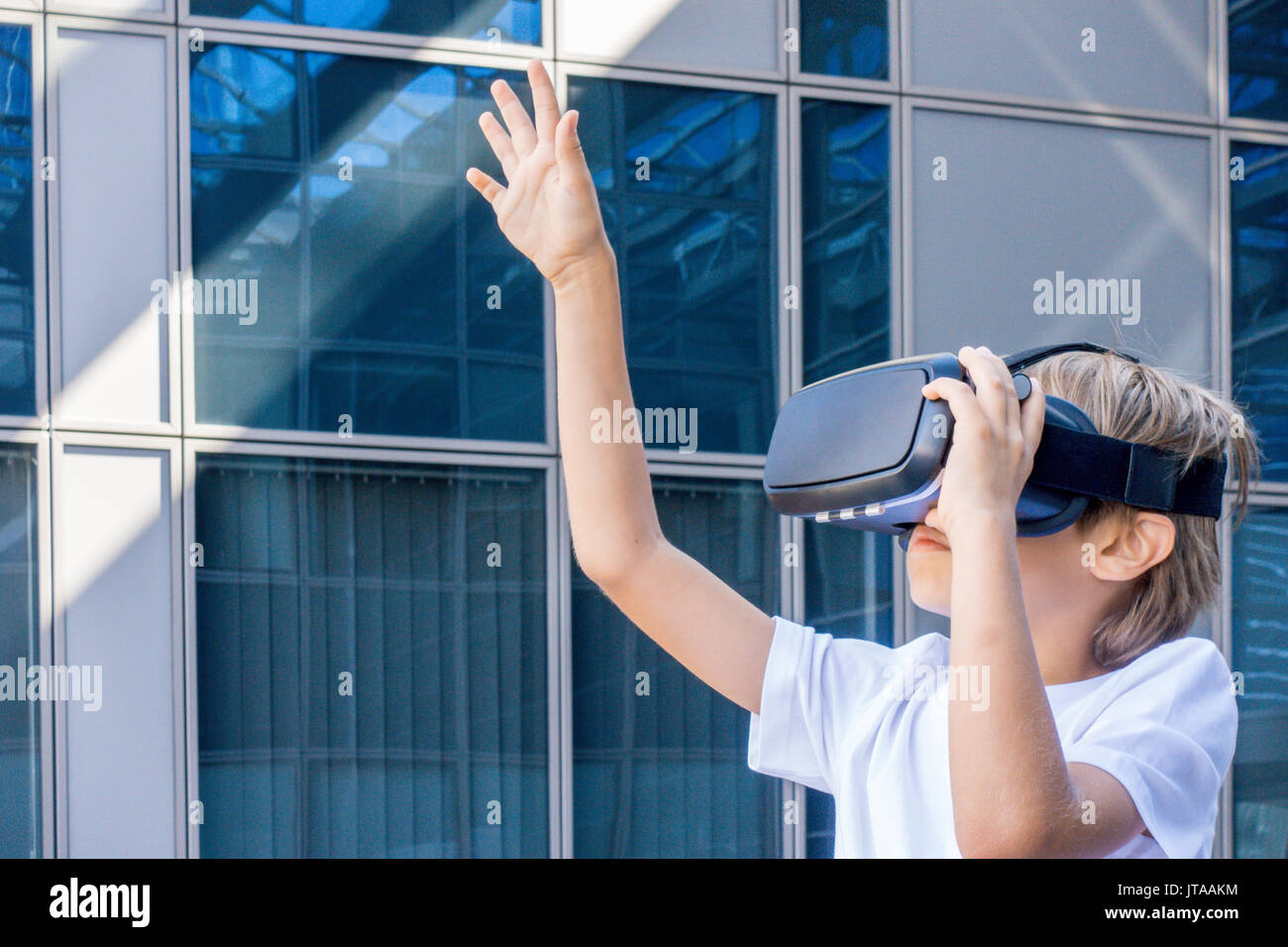 Young boy with virtual reality goggles in the city Stock Photo - Alamy