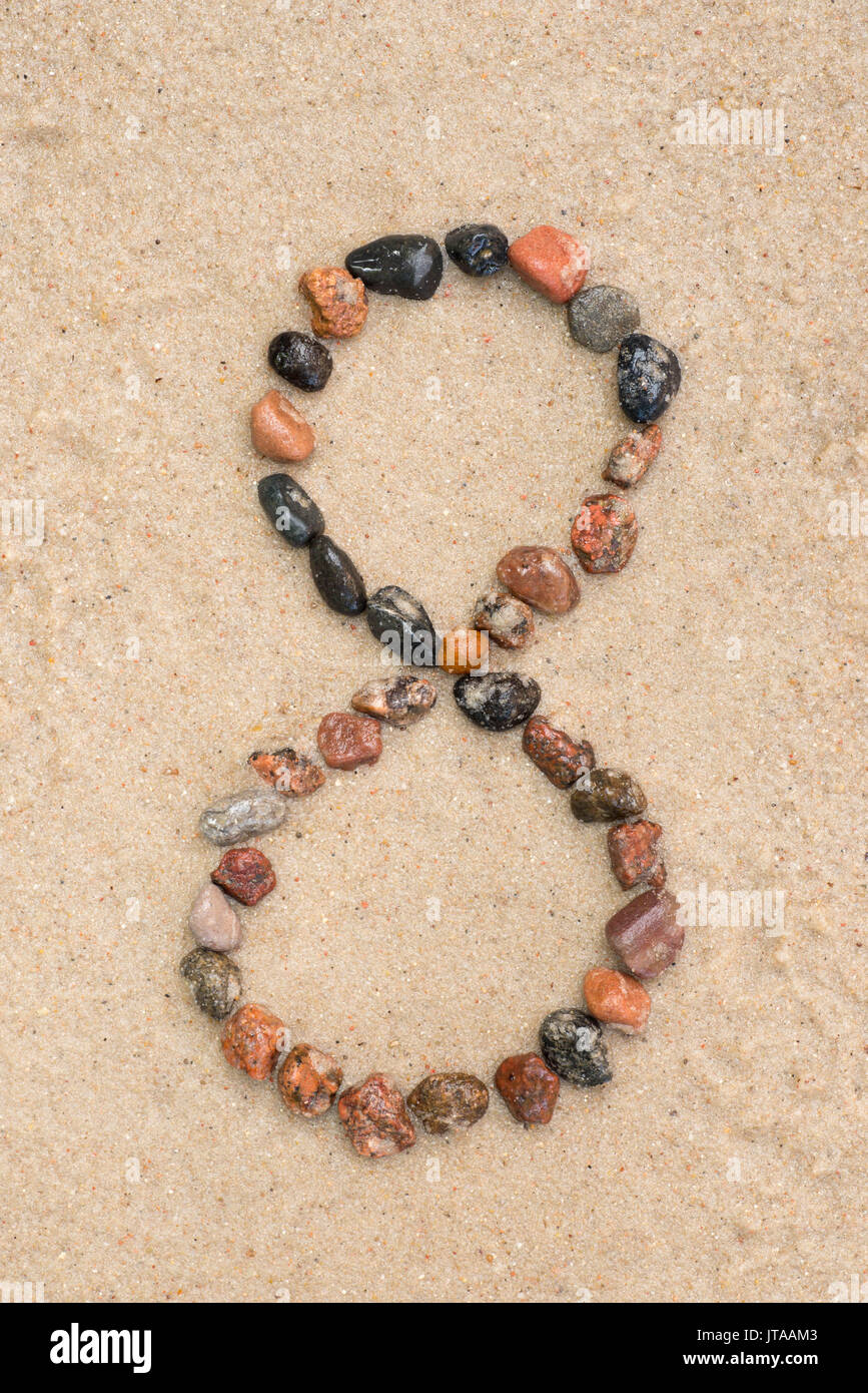 pebble 8 number on sand background selective focus Stock Photo - Alamy