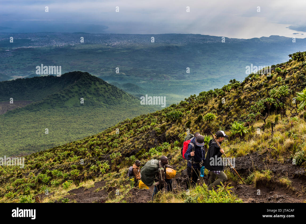 Trekkers on the steep slopes of Mount Nyiragongo, Virunga National Park ...
